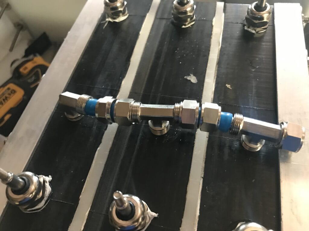 FITTING THE METAL GAS FITTINGS TO THE CELLS