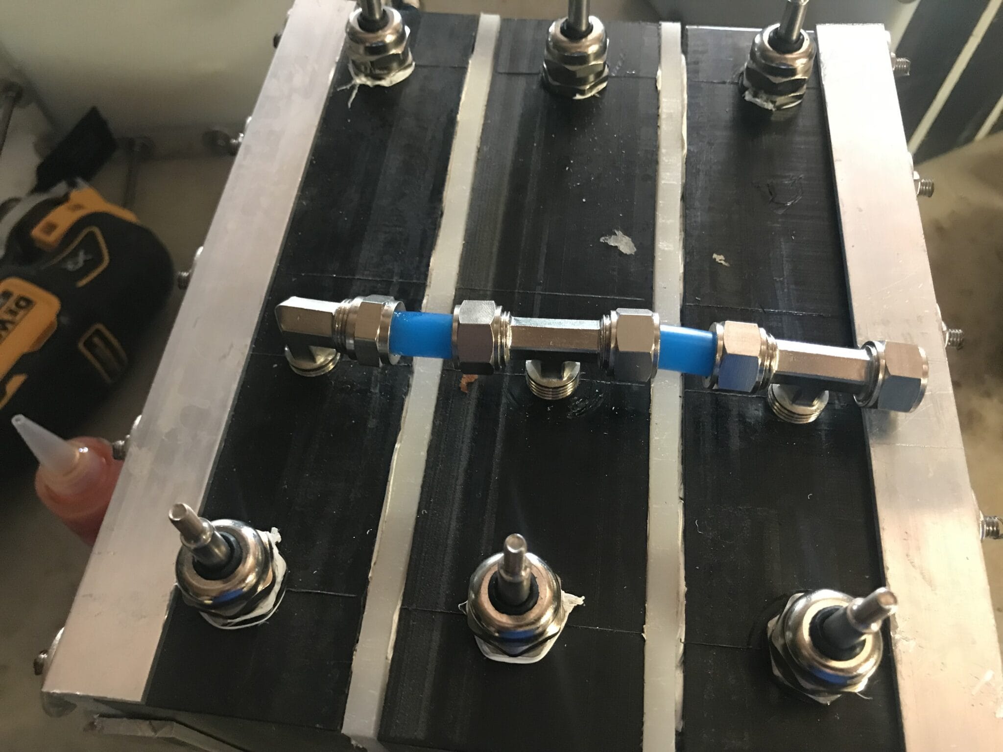 FITTING THE METAL GAS FITTINGS TO THE CELLS
